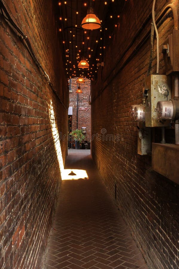 Looking Down a Softly Lit Alley with Warm Red Bricks Stock Photo ...