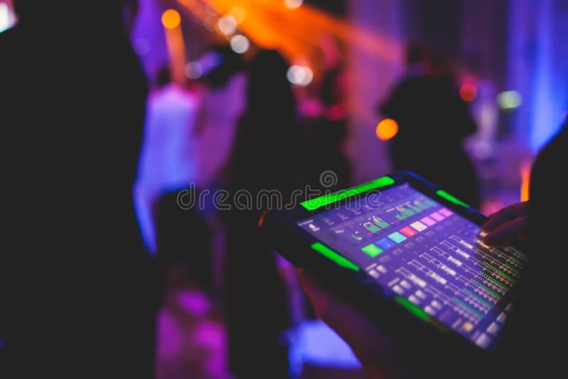 View of Lighting Technician with Tablet, Operator Controlling Sound and ...