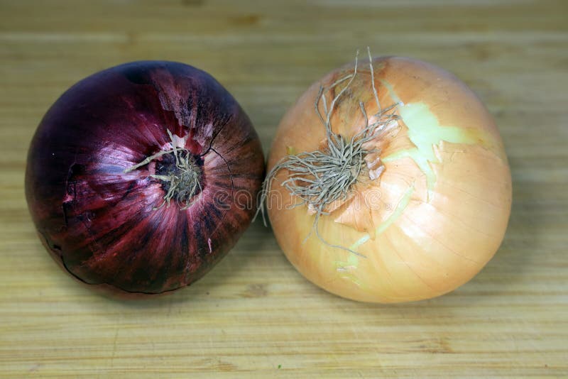 A View Looking Down on a Group of Three Onions on a Worn Butcher Block ...