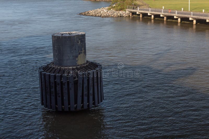 View Looking Down on a Modern Dolphin Pier Piling in the Shadow of a ...
