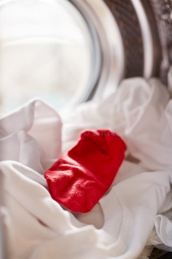 View Looking Out from Inside Washing Machine with Red Sock Mixed with ...