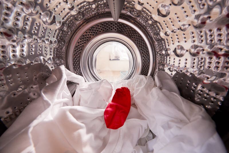 View Looking Out from Inside Washing Machine with Red Sock Mixed with ...