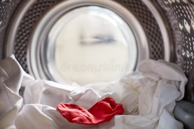 View Looking Out from Inside Washing Machine with Red Sock Mixed with ...
