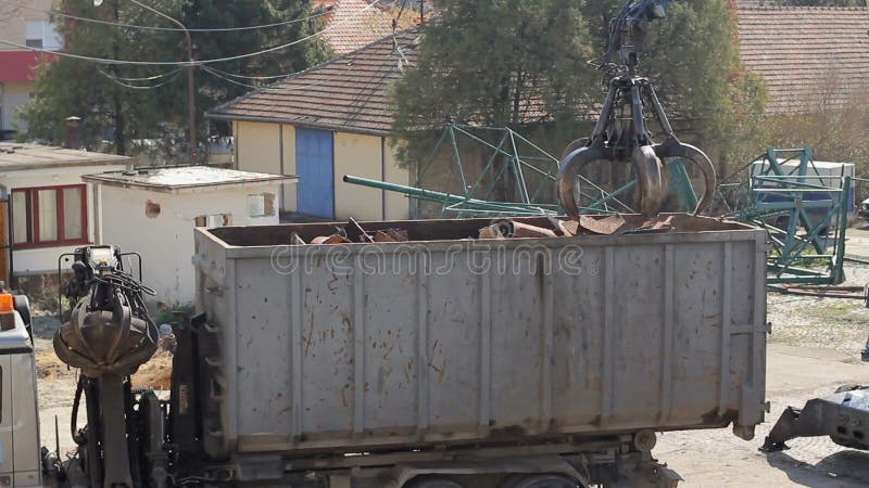 Loader Manipulator with Hydraulic Grappling Claw is Loading Scrap Metal ...