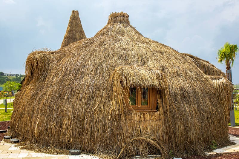 View of Made of Straw Rural House in the Field Under Cloudy Spring Day ...