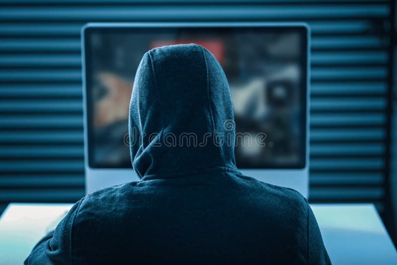 View of Man in Hood Sitting in Front of Computer Stock Photo - Image of ...