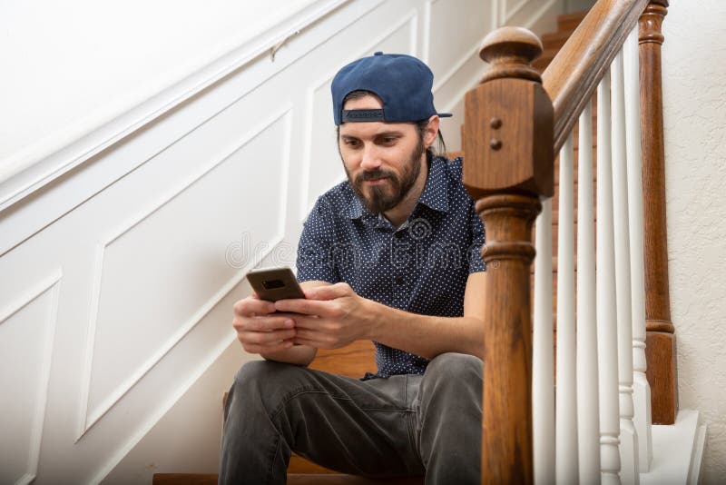Man Sits on Stairs with Phone Stock Image - Image of video, call: 177398493