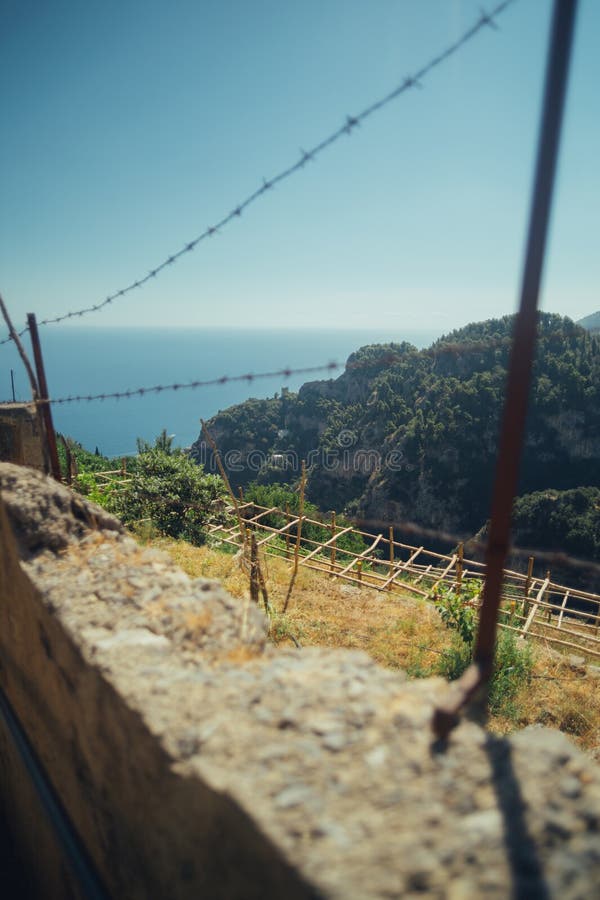 View of Mediterranean Coastline through Rustic Wooden Frame and Barbed ...