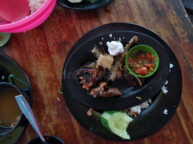 View of a Messy Table with Chicken Bones and Fish Bones on a Black ...
