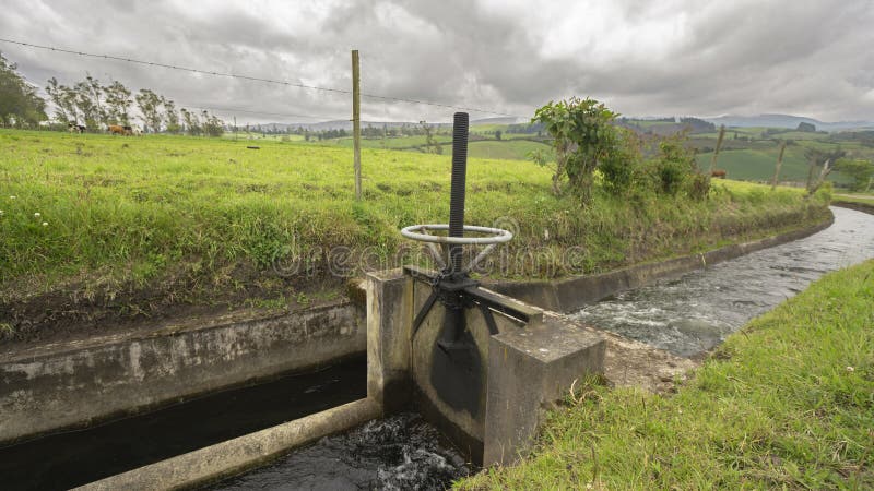 View of a Metal Gate of an Irrigation Canal with a Background of ...
