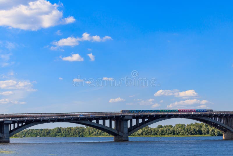 View of Metro Bridge with Subway Train Passing and the Dnieper River in ...