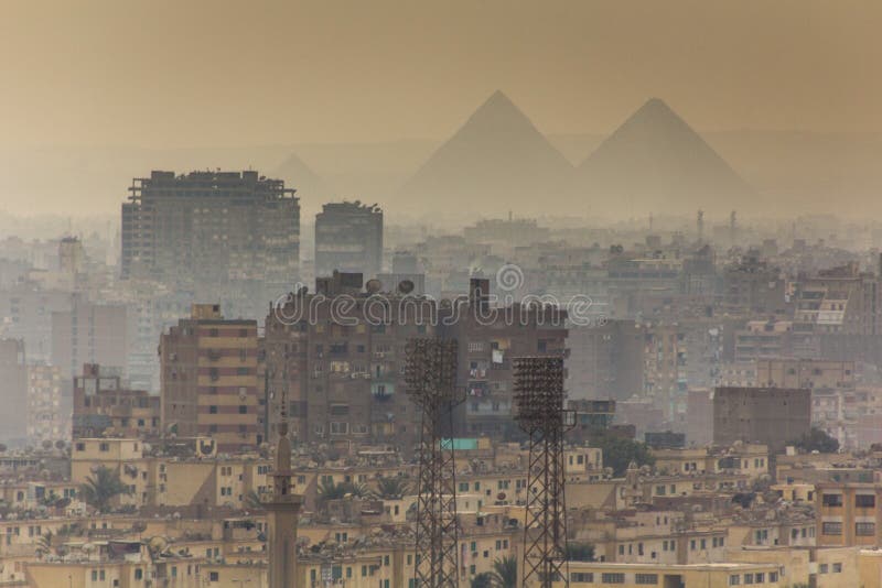 View of Misty Cairo Skyline with Pyramids in the Background, Egy Stock ...