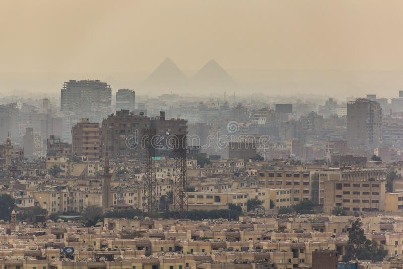View of Misty Cairo Skyline with Pyramids in the Background, Egy Stock ...