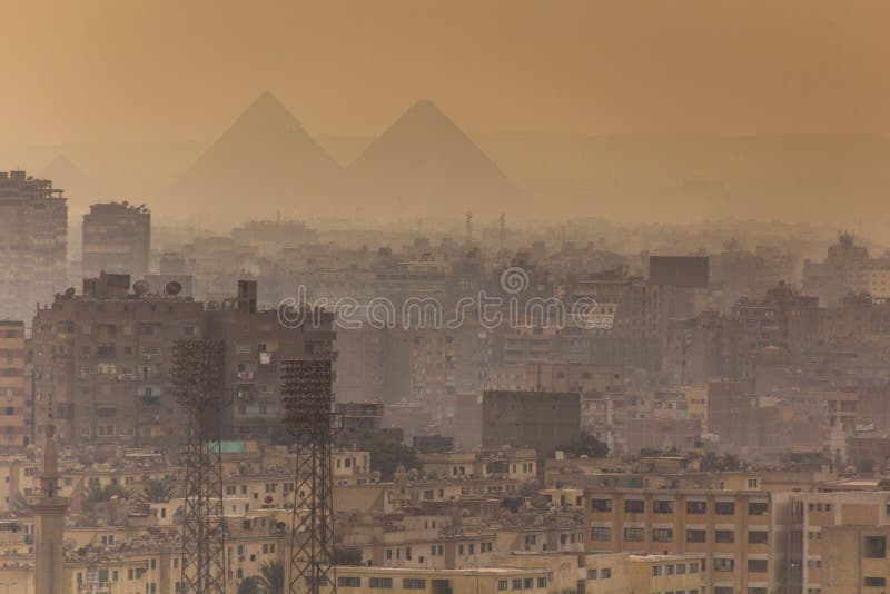 View of Misty Cairo Skyline with Pyramids in the Background, Egy Stock ...