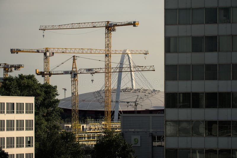 View of Modern Construction Cranes Towering Over a Large Structure in a ...