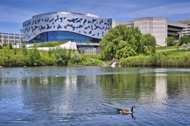 View of a Modern Design Building Exterior with a Pond in the Foreground ...