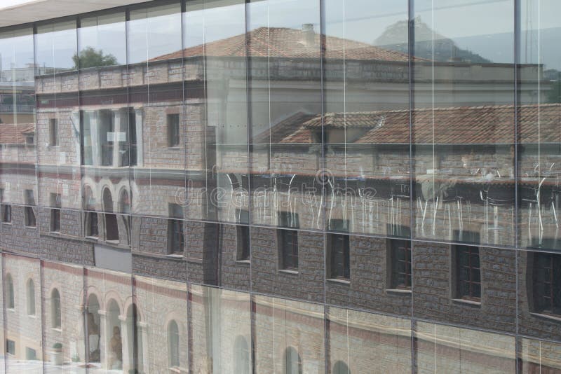 View of Modern Glass Building with Reflection of a Brick Building Stock ...