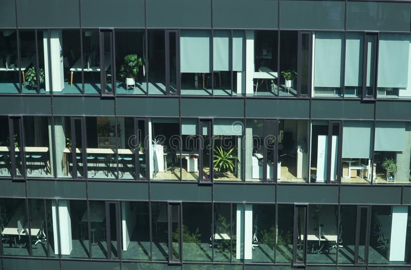 A View of a Modern Office Building , with Workspaces Visible through ...