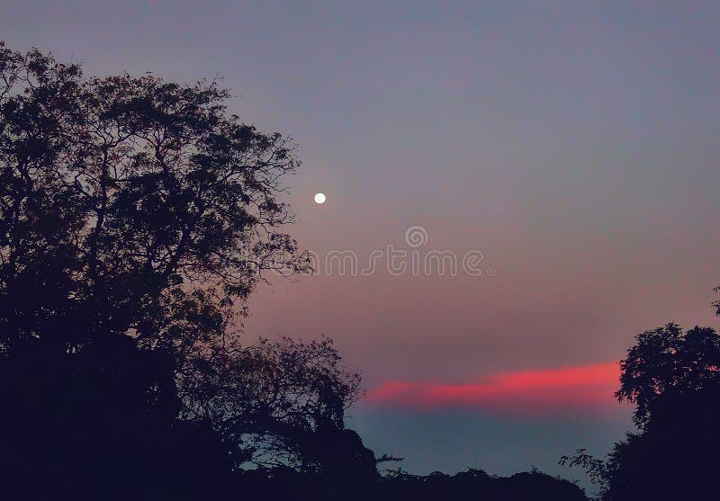 A Beautiful Twilight Moon and a Cloud with Sunlight Reflection Stock ...