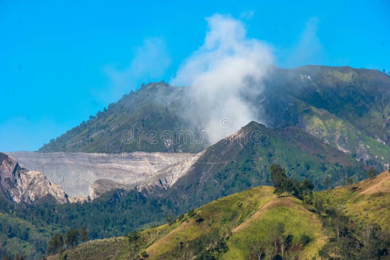 View of Mountain Ridges and Sloping Hills with Trees Under a Clear Blue ...