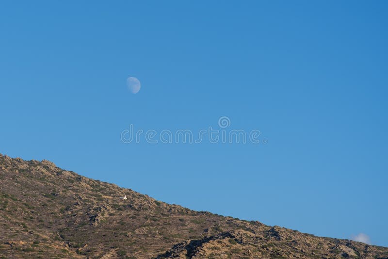 Day moon in Ios Greece stock image. Image of mountains - 259641851