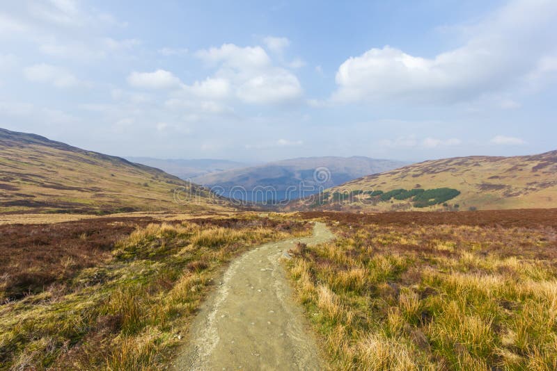 A View of a Mountain Valley with Path,grass and Lake in the Background ...