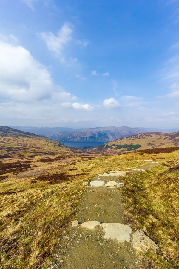 A View of a Mountain Valley with Path,grass and Lake in the Background ...