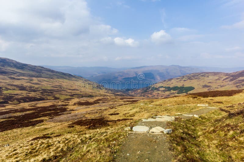A View of a Mountain Valley with Path,grass and Lake in the Background ...