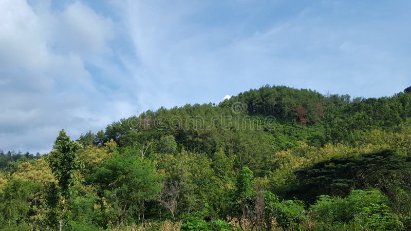 A View of the Mountains Against a Background of White Cloudy Blue Sky ...