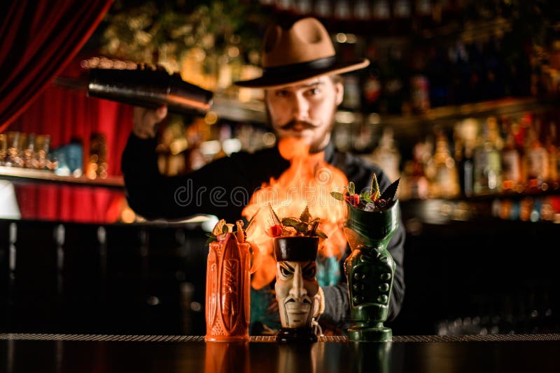 View of Glasses on Bar Counter and Bartender Sets Them on Fire Stock ...
