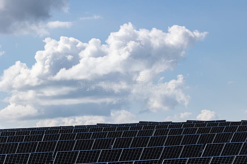 View of Multiple Solar Panels Against the Sunny Cloudy Sky Stock Photo ...