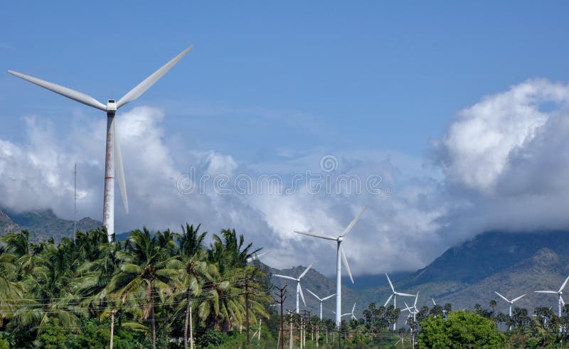 Multiple Wind Turbines Standing on a Hill at Sunset and Generating ...