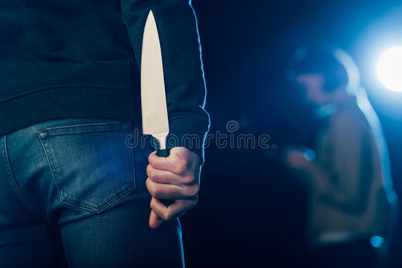 View of Murderer Hiding Knife Behind Back on Black Stock Photo - Image ...