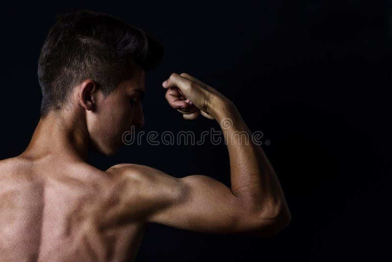 View of Muscular Teenager Flexing Biceps in Front Black Backgrou Stock ...