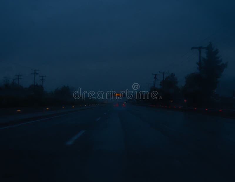 View of Night Highway through the Windshield of a Car at Speed in Rainy ...