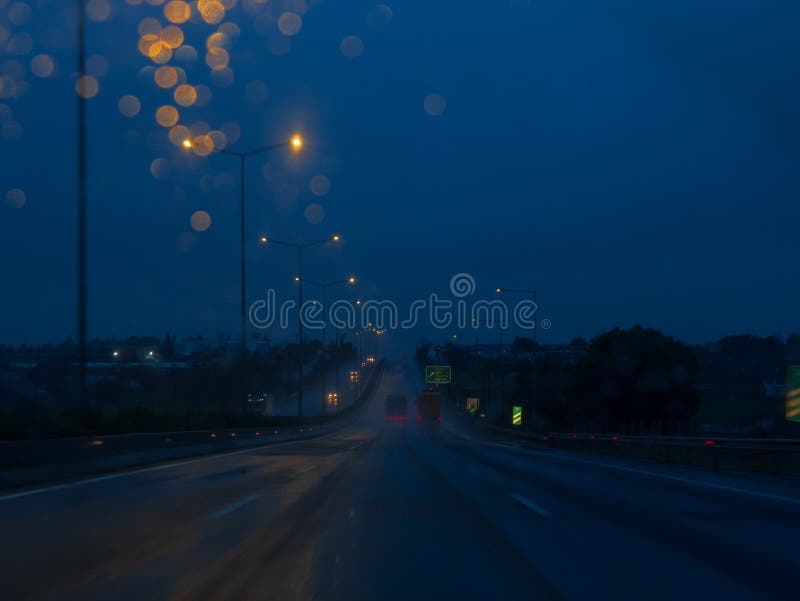 View of Night Highway through the Windshield of a Car at Speed in Rainy ...