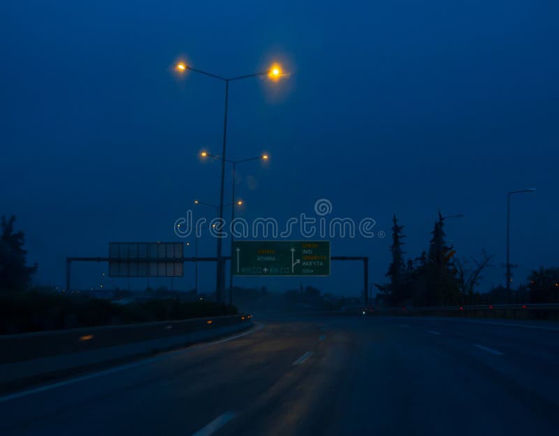View of Night Highway through the Windshield of a Car at Speed in Rainy ...