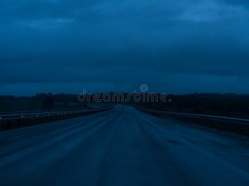 View of Night Highway through the Windshield of a Car at Speed in Rainy ...
