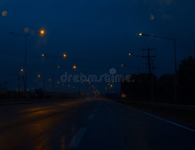 View of Night Highway through the Windshield of a Car at Speed in Rainy ...