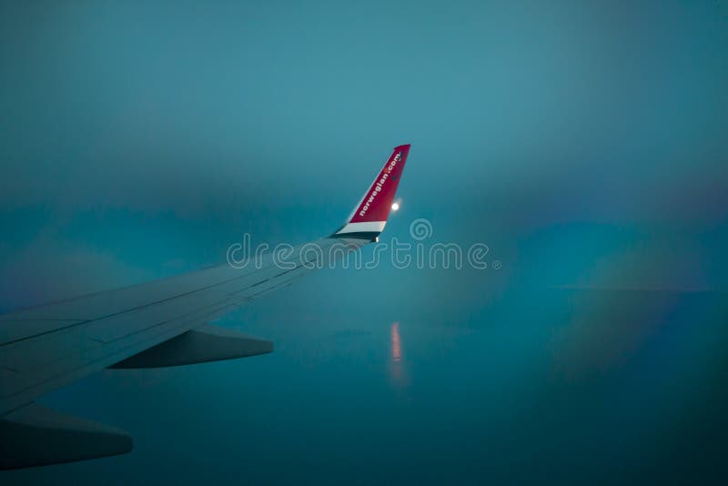 View from Norwegian Airplane Window with Blue Sky and White Clouds. 08. ...