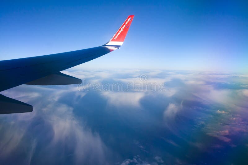 View from Norwegian Airplane Window with Blue Sky and White Clouds. 08. ...