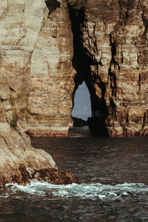 A View of the Ocean through an Arch in Rock Formation, Faroe Islands ...