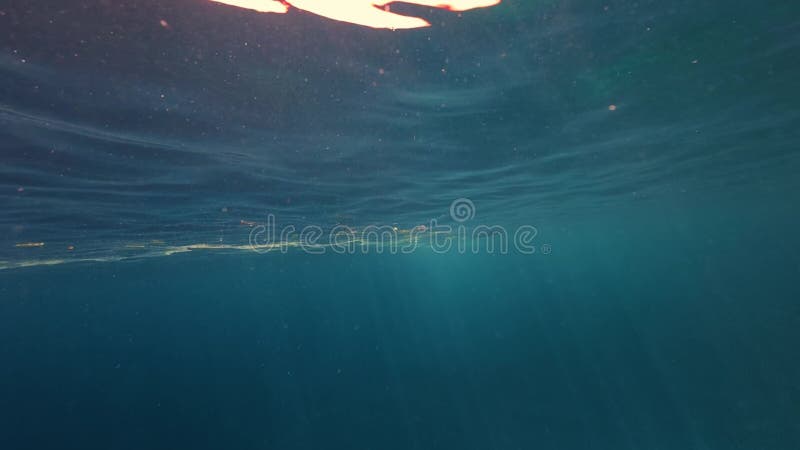 View of the Ocean Water Surface from Underwater. Bright Rays of the Sun ...
