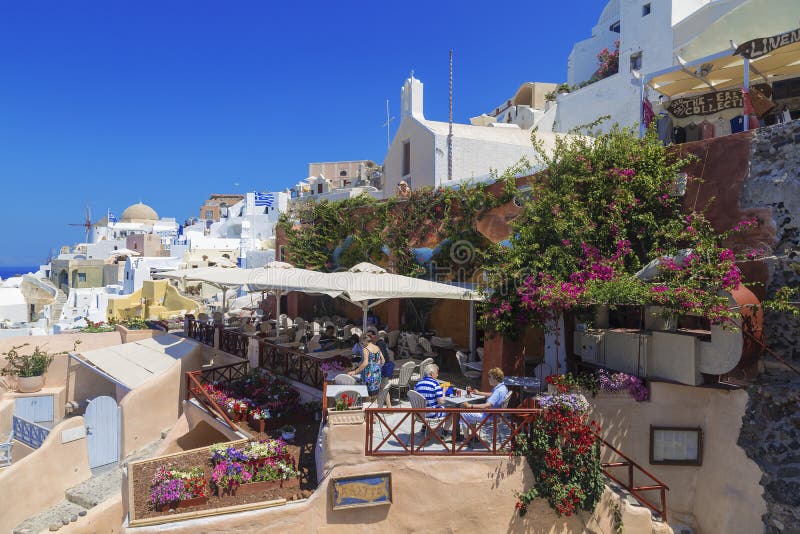 View on Oia Town with a Cafe on the Foreground. Santorini Editorial ...