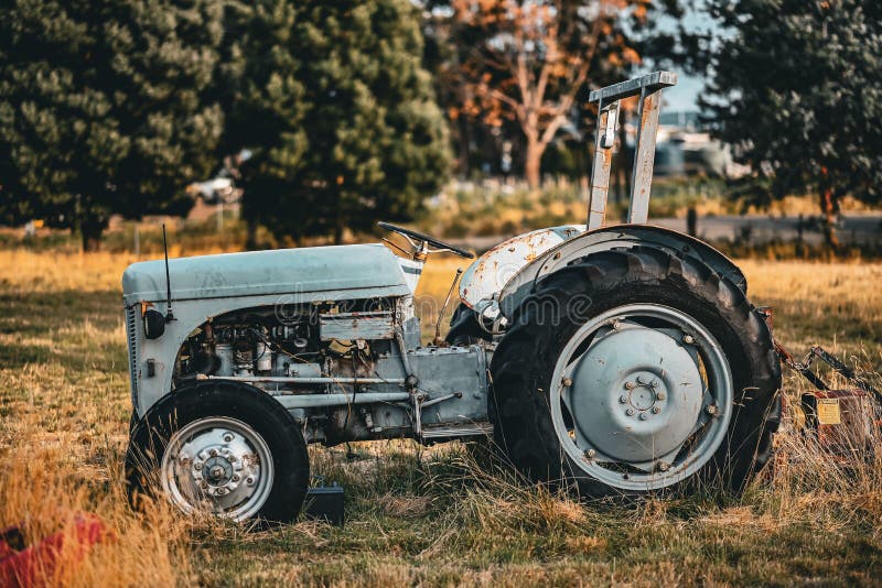 View of an Old Rusty Tractor in a Field with Dry Grass Stock Image ...