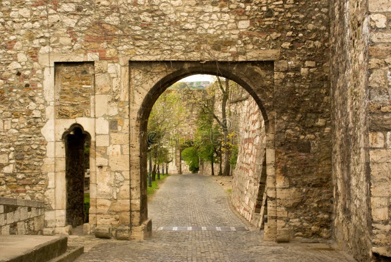 View through Old Stone Arc on Pavement Stock Photo - Image of road ...