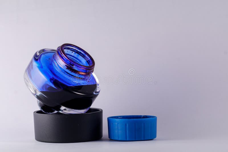 A View of Open Blue Ink Bottle Against White Background Stock Photo ...