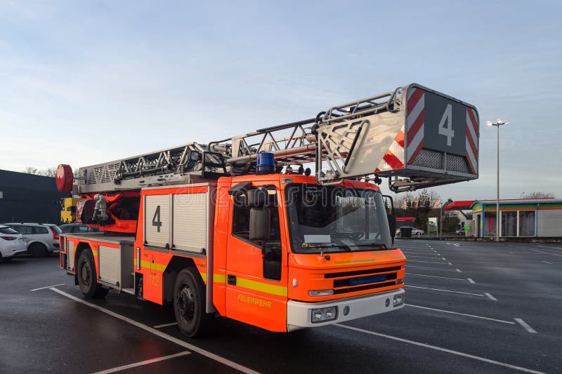 View of an Orange Fire Truck Standing in a Large Parking Lot. Stock ...