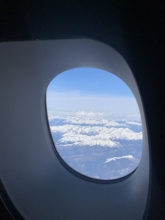 View Over the Alps from an Airplane Window Mid-flight Stock Image ...