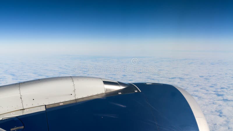 View Over a Blue Aircraft Engine at High Altitude Above White Clouds ...